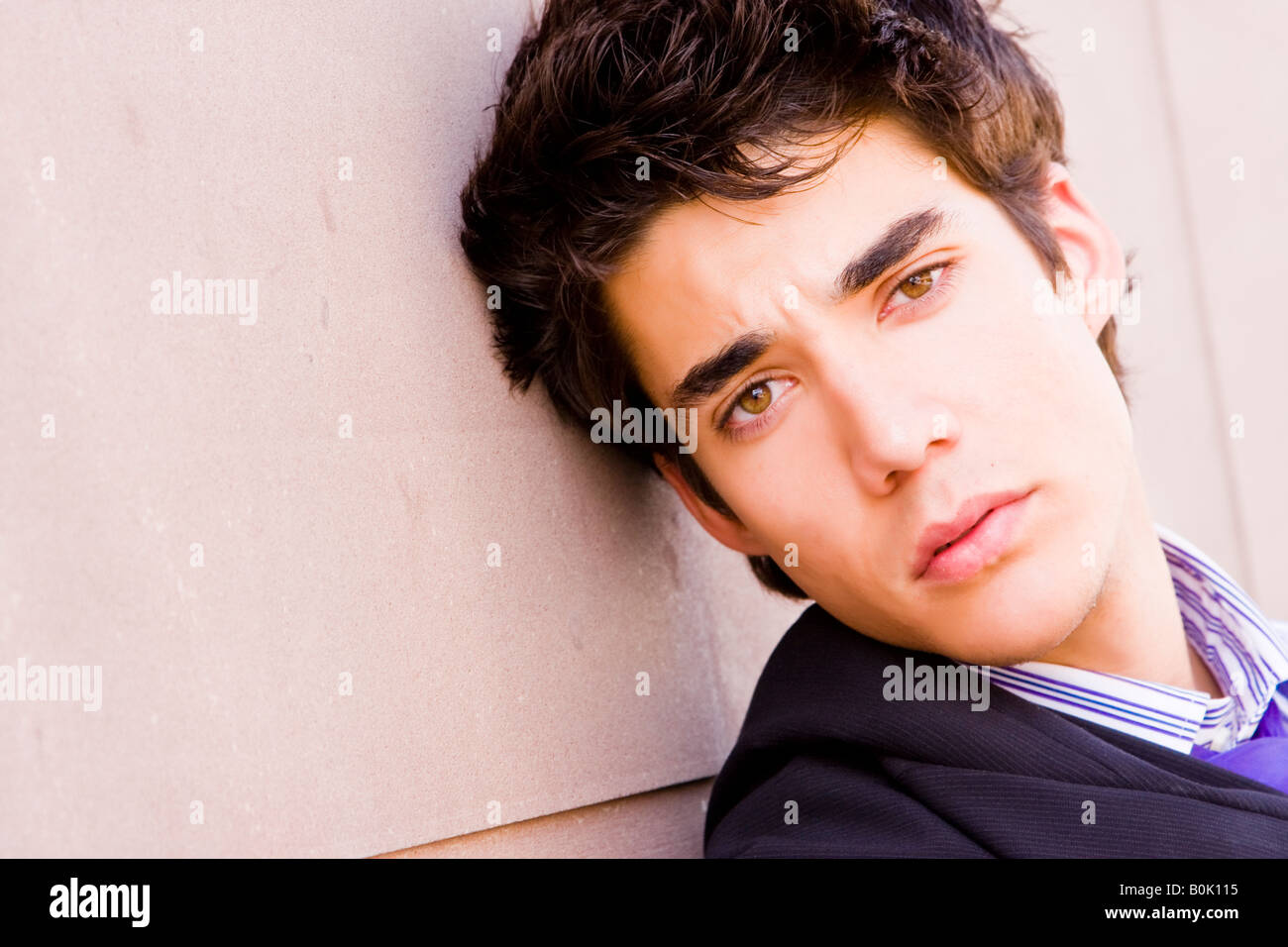 Attractive male model on wall Stock Photo - Alamy
