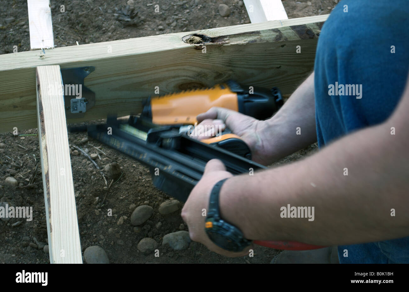 nailing sing a nail gun Stock Photo - Alamy