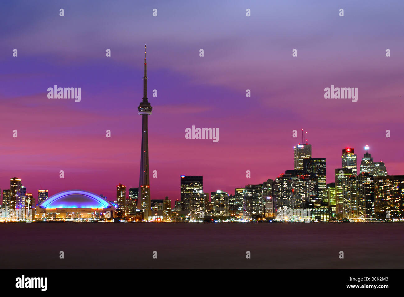 The Toronto skyline with the CN tower during sunset with a pink sky ...