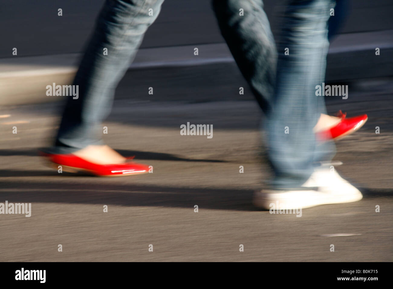 woman wearing red shoes walking in town Stock Photo - Alamy