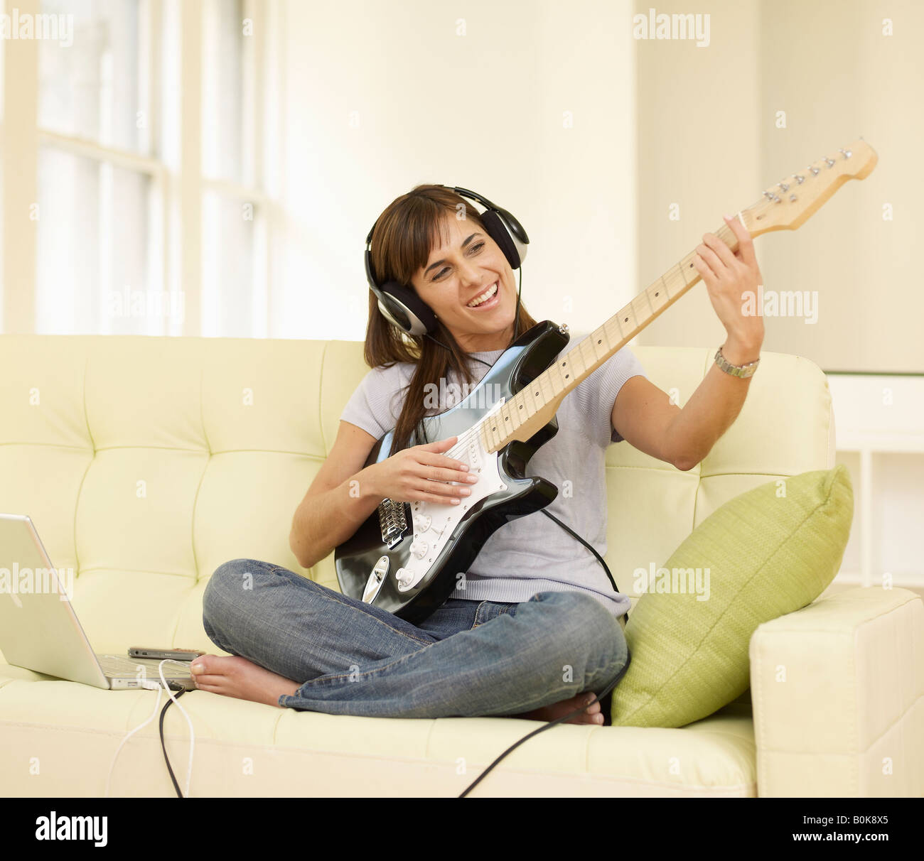 Playing guitar inside woman hi-res stock photography and images - Alamy
