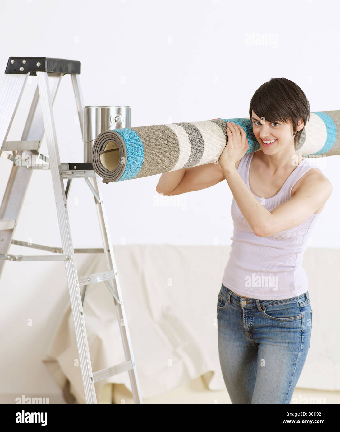 Young Woman Carrying Rug Stock Photo - Alamy