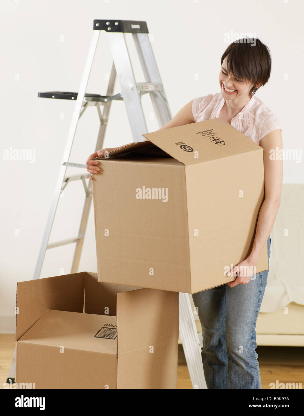 Young Woman Carrying Cardboard Box Stock Photo - Alamy