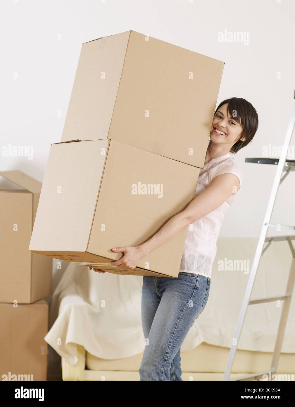 Woman carrying stack of cardboard boxes hi-res stock photography and ...