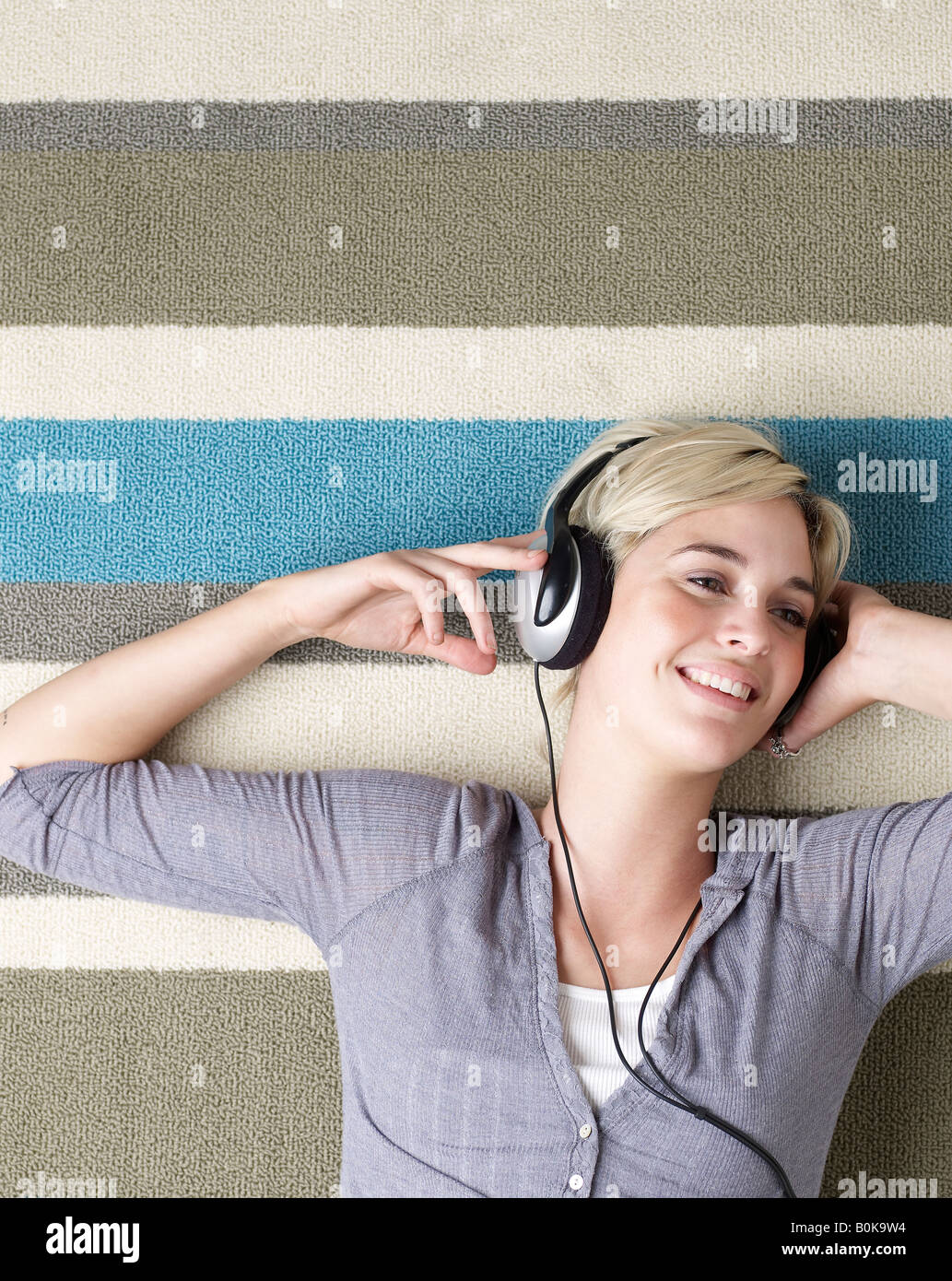 Young Woman Listening to Headphones Stock Photo - Alamy