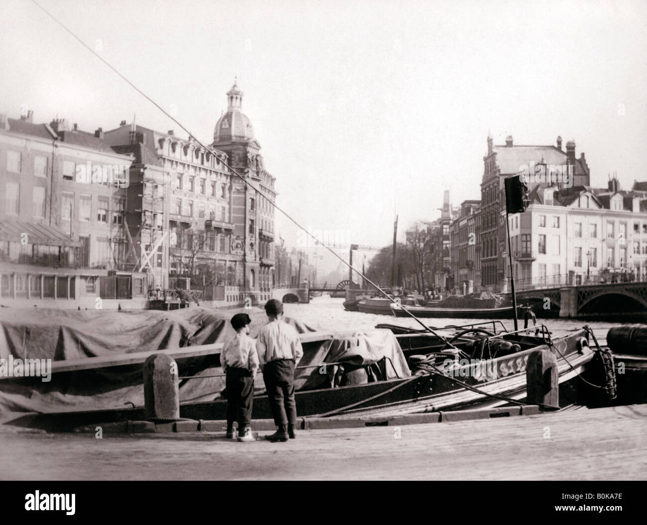 Two boys by a canal, Rotterdam, 1898.Artist: James Batkin Stock Photo ...