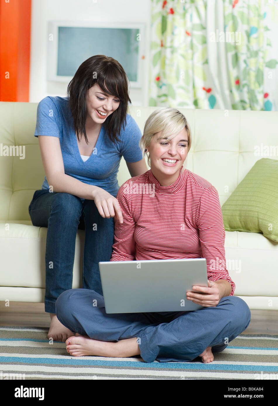 Two Young Women Using Laptop Stock Photo - Alamy