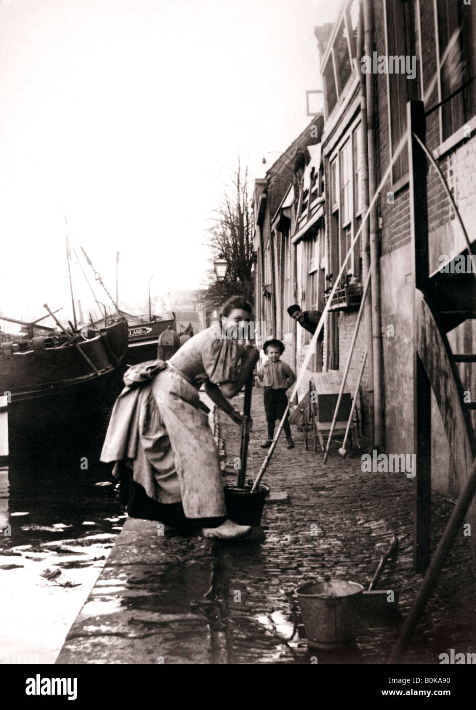 Woman mopping the street, Dordrecht, Netherlands, 1898.Artist: James ...