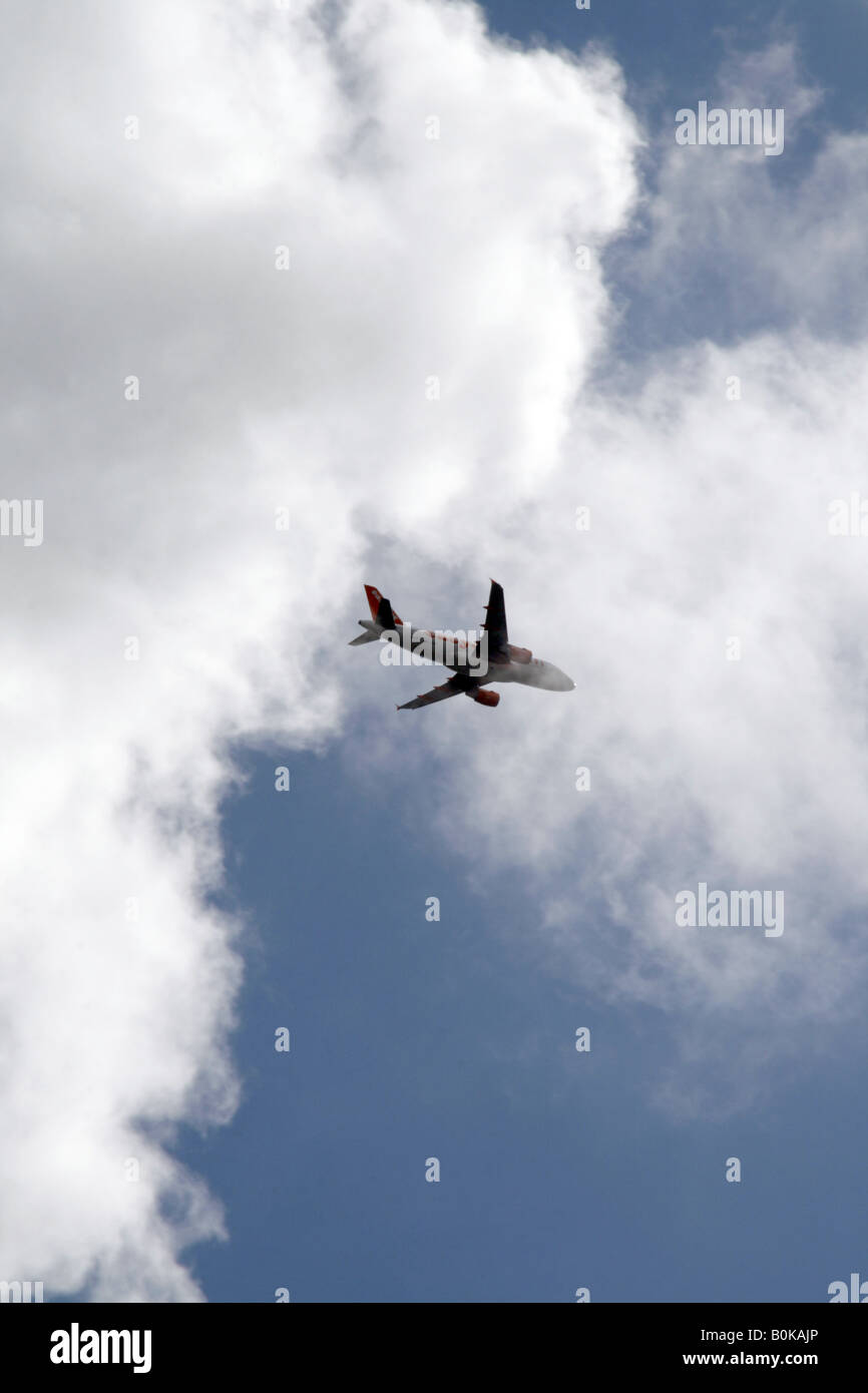 easyjet plane flying through dark clouds in sky Stock Photo - Alamy