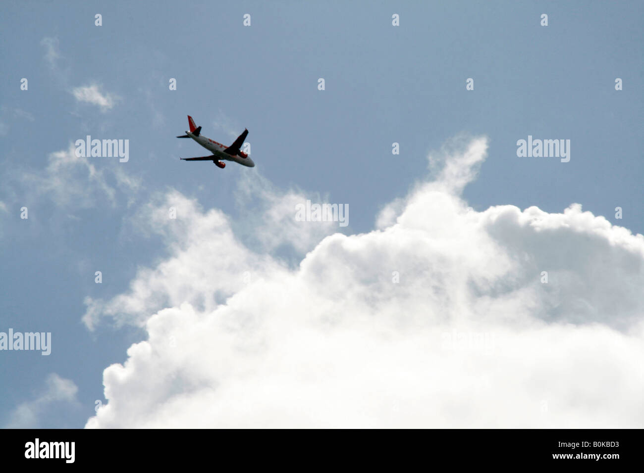 easyjet plane flying through dark clouds in sky Stock Photo - Alamy