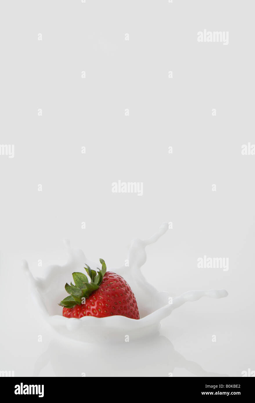 Strawberry Falling into Milk Stock Photo - Alamy