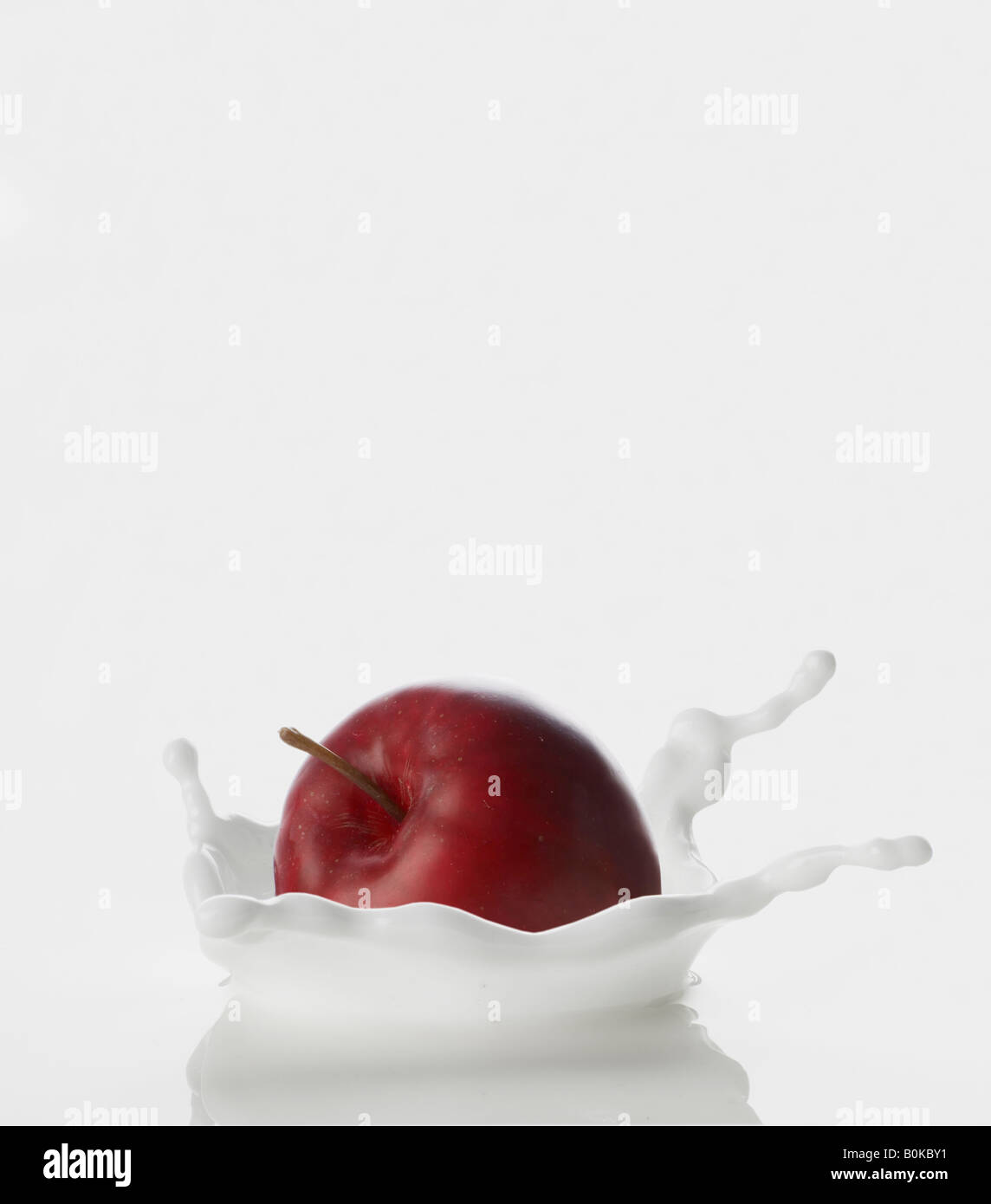 Apple Falling Into Milk Stock Photo - Alamy