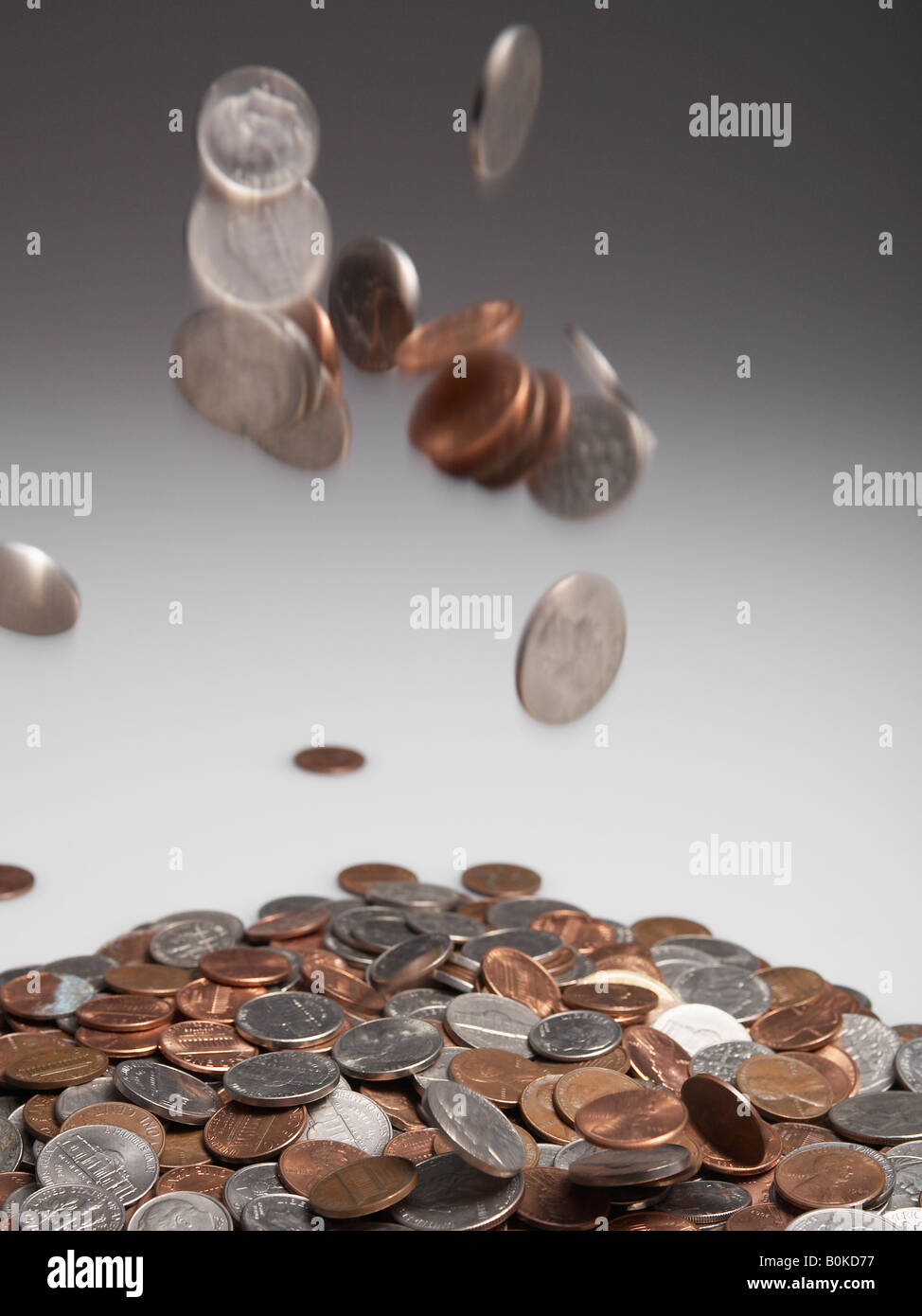 Coins Falling on Pile Stock Photo - Alamy
