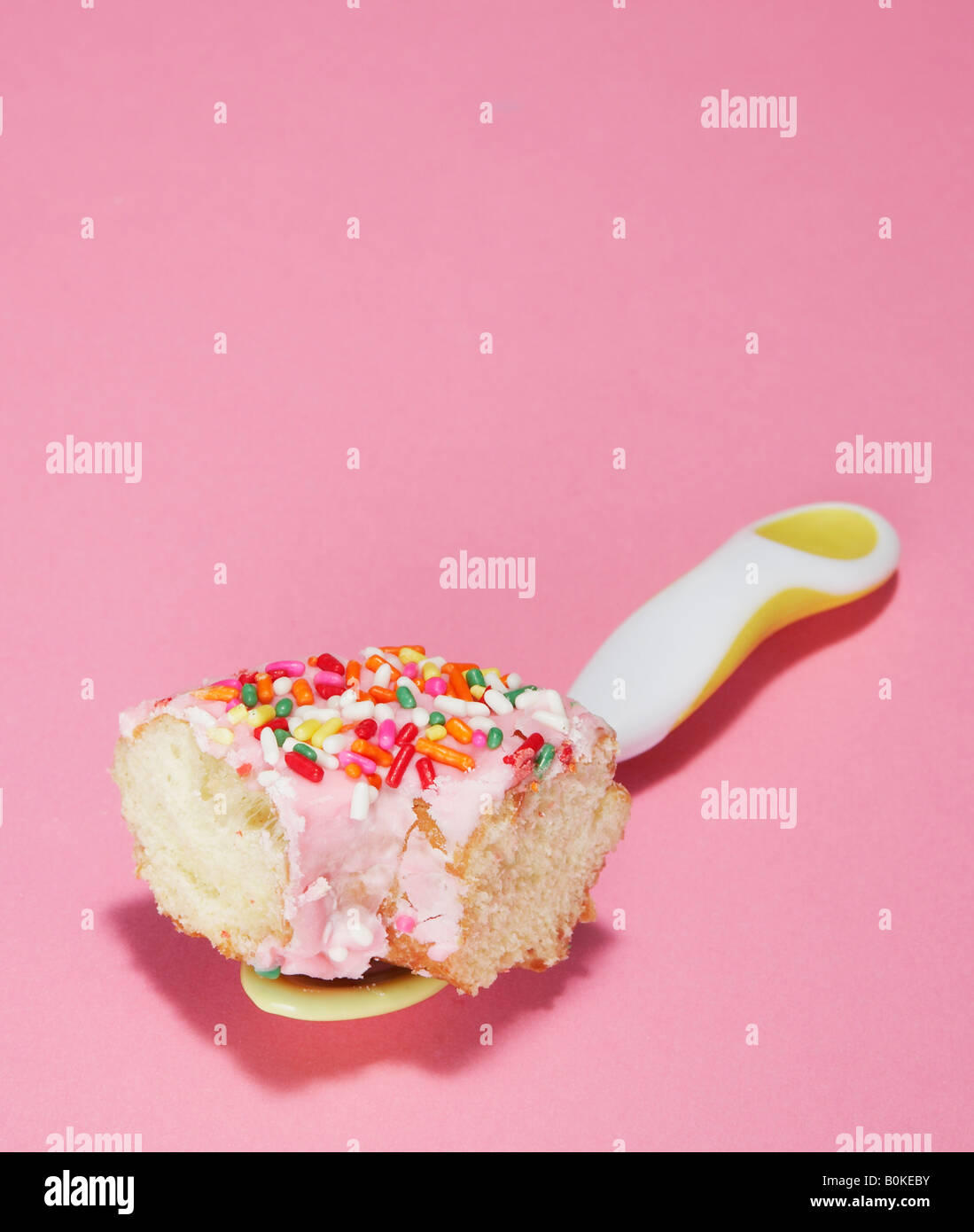 Piece of Doughnut on Spoon Stock Photo - Alamy
