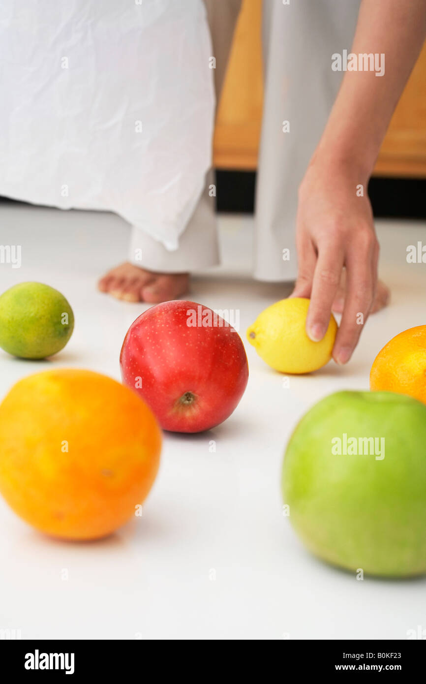Woman Arranging Fruits on Floor Stock Photo - Alamy