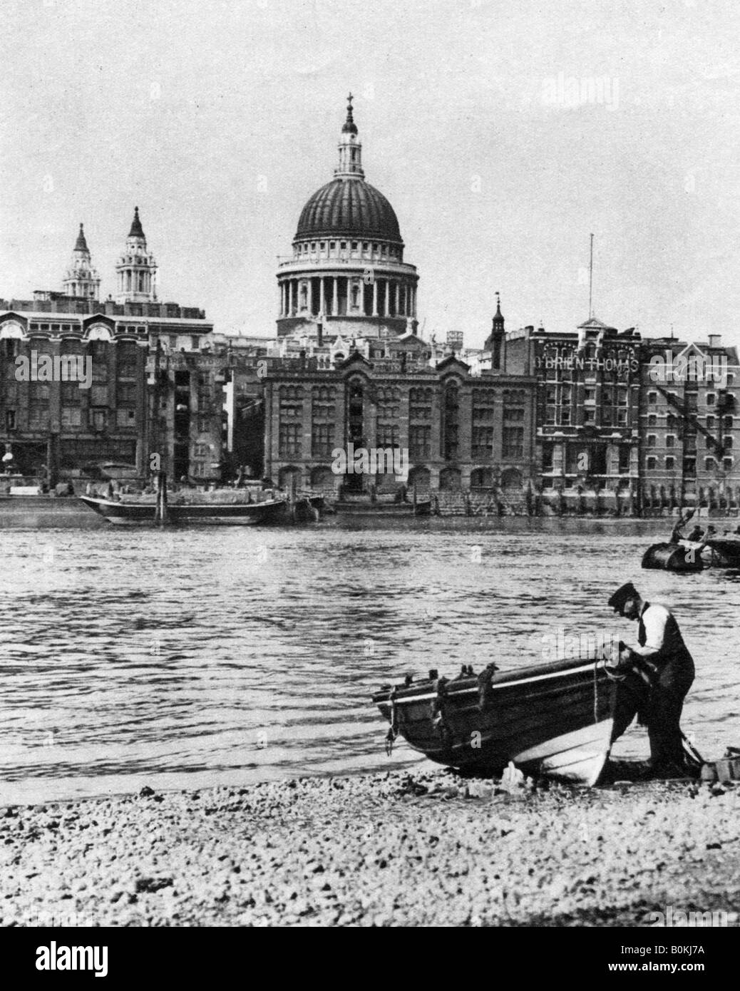 Thames waterman and his boat on the 'beach' at Bankside, London, 1926 ...