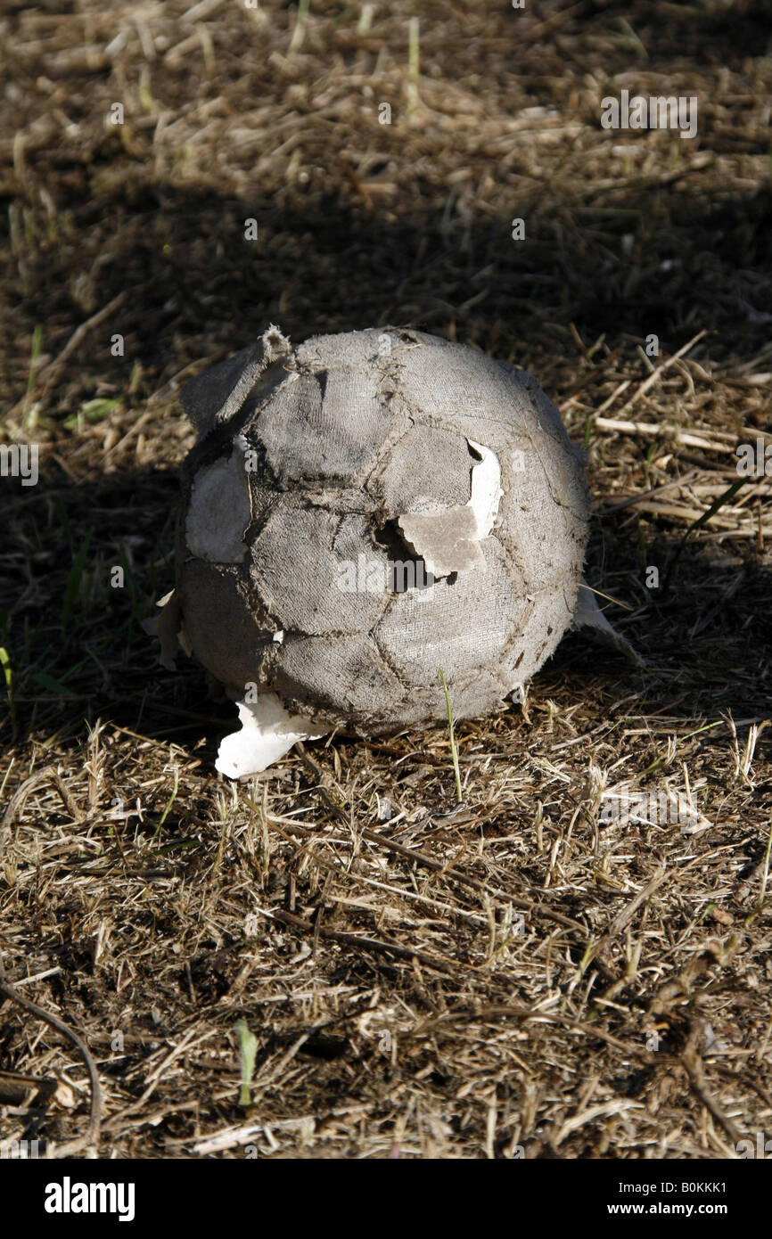one old damaged football in field Stock Photo - Alamy