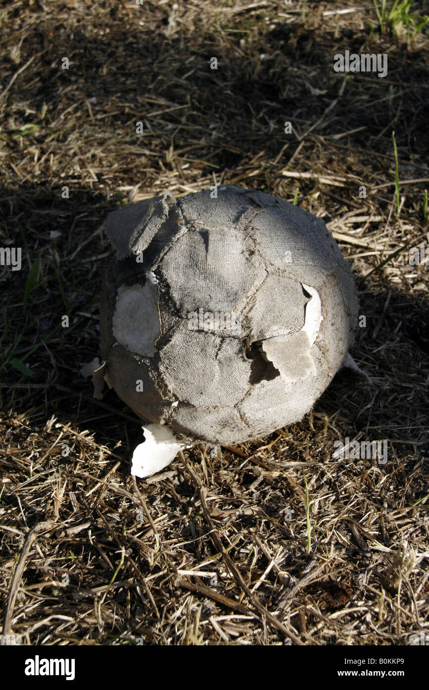 one old damaged football in field Stock Photo - Alamy