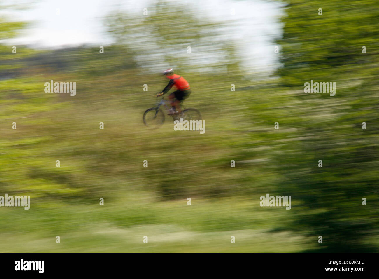 person riding fast bike in countryside Stock Photo - Alamy