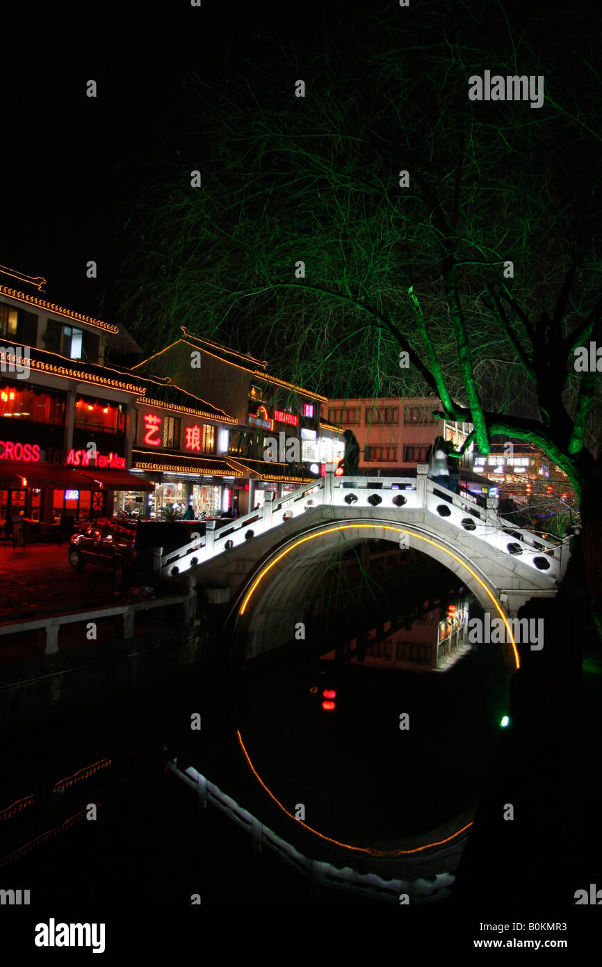 Traditional stone bridge over the grand canal in Suzhou, with multi ...