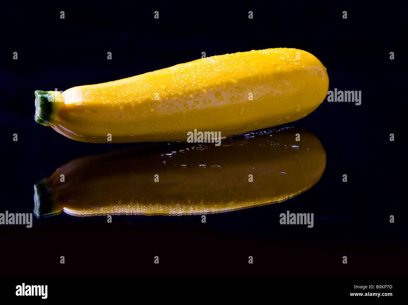 Yellow zucchini on black background Stock Photo - Alamy