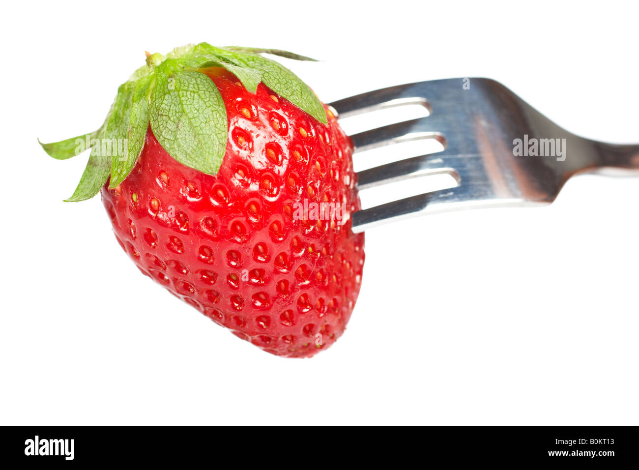 The fork pricking the strawberry isolated on white background Shallow ...