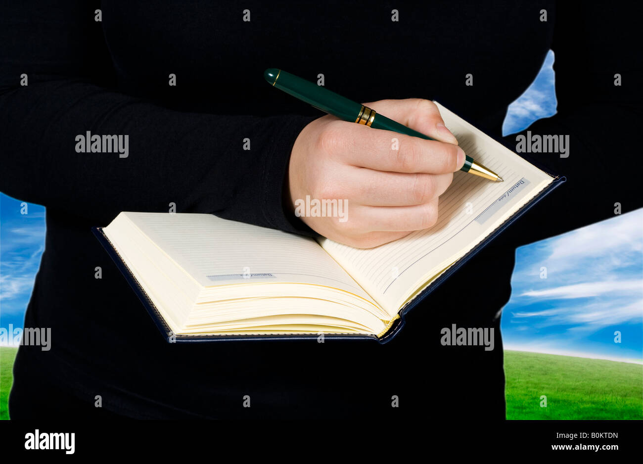 Close up of a hand starting to write in a blank notebook Studio shot ...