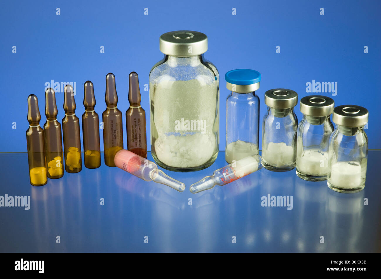 Arrangement of assorted medical vials on blue background Stock Photo ...