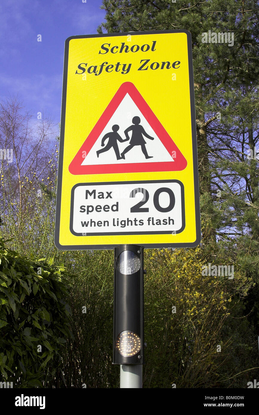 A roadside speed restriction warning sign outside a school Stock Photo ...