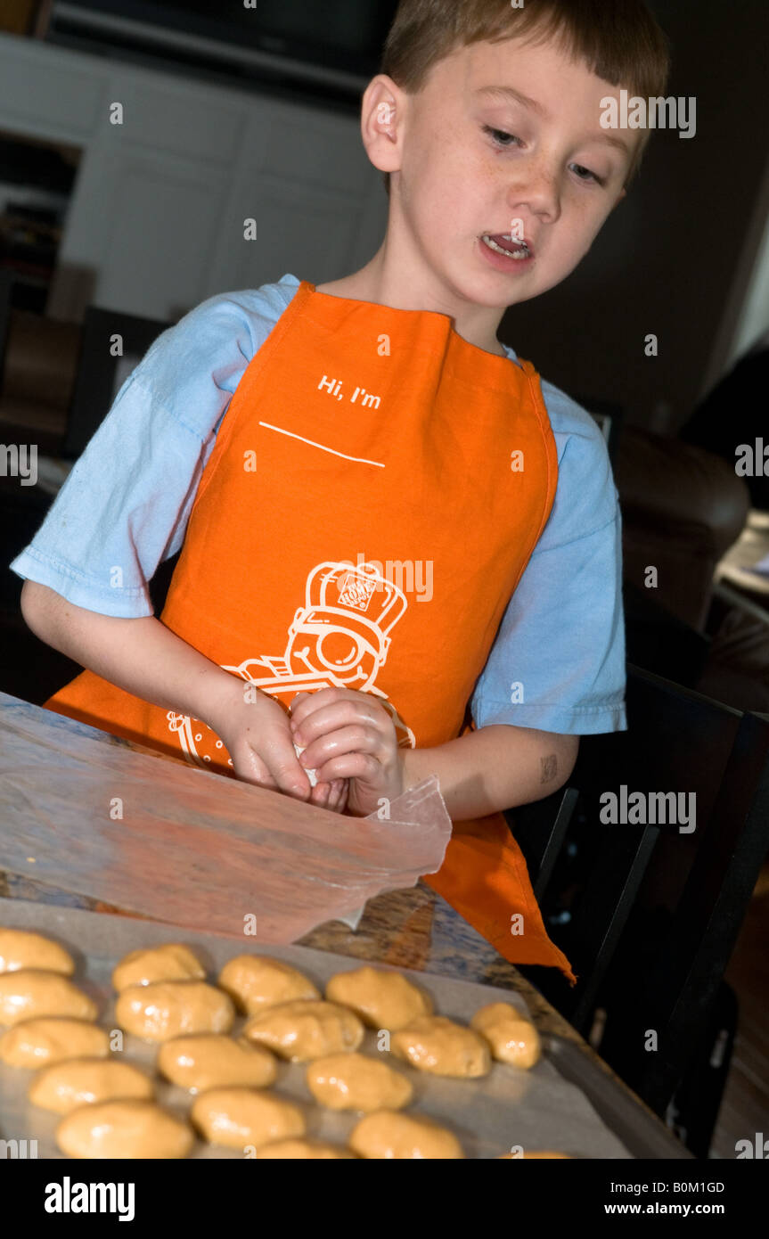 Family activity making home made chocolate covered peanut butter eggs a ...