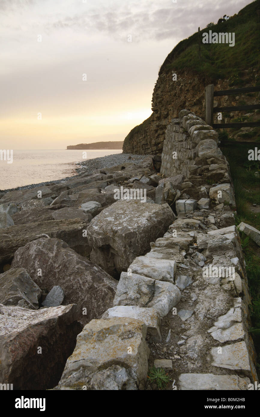 Coast wall cliff bay pebbles dusk dawn sunrise sunset glow orange ...