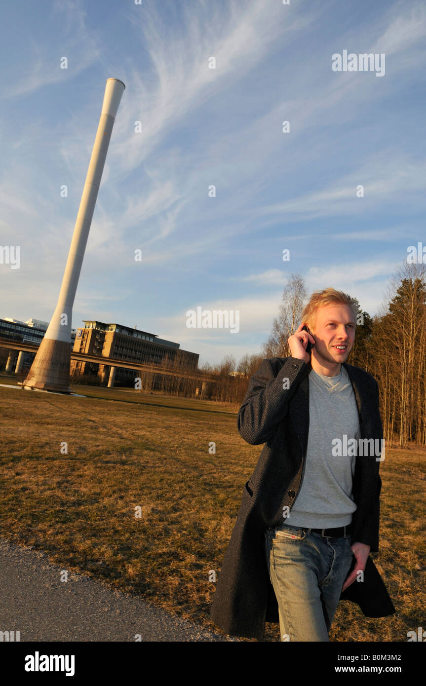 Young swedish man calling with a cell phone in front of the Ericsson ...