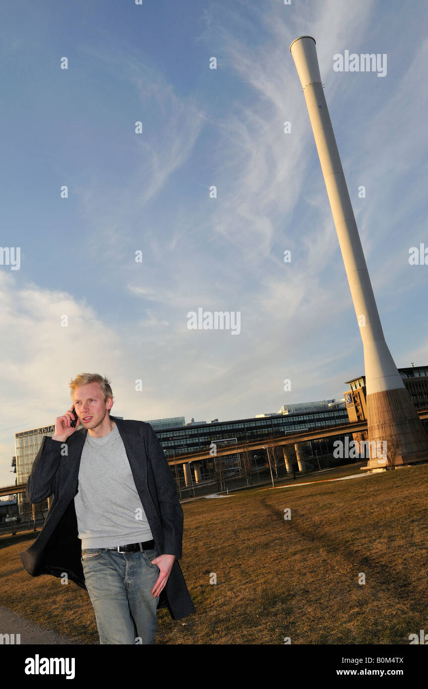 Young swedish man calling with a cell phone in front of the Ericsson ...