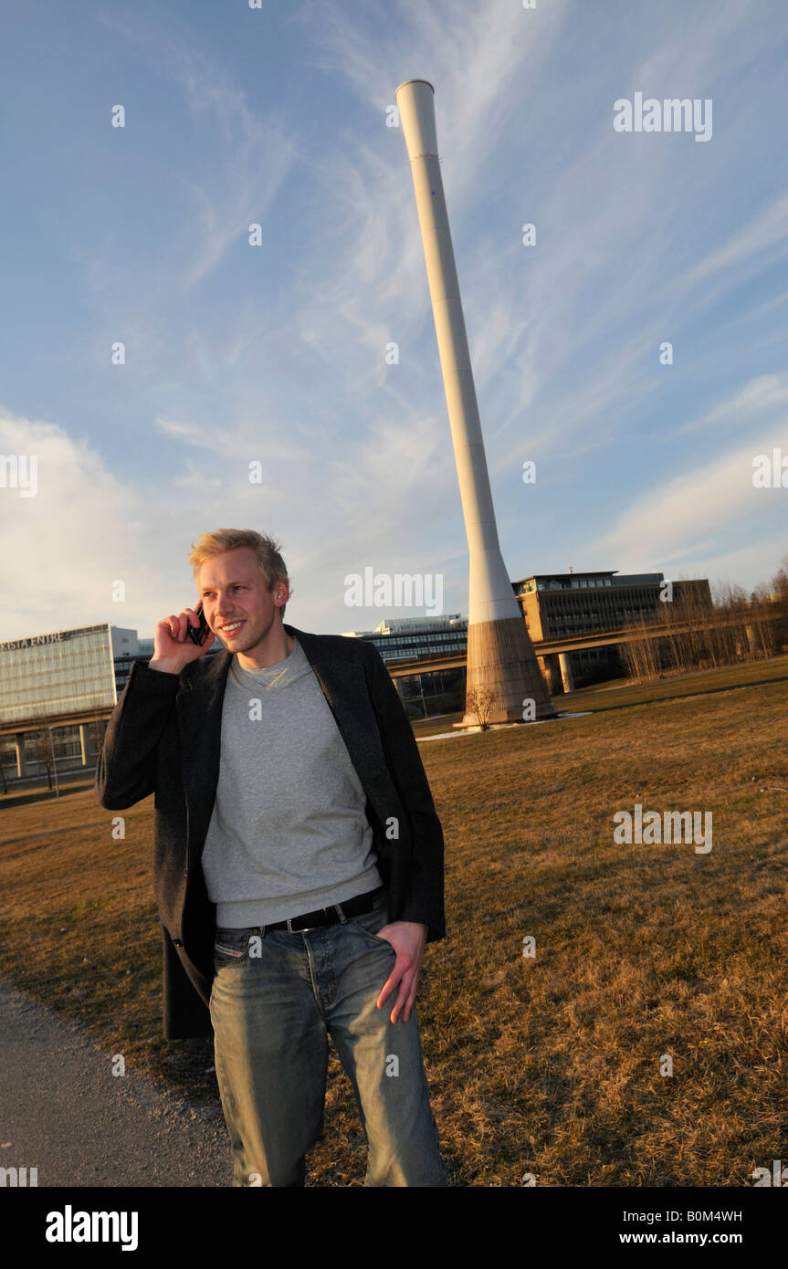 Young swedish man calling with a cell phone in front of the Ericsson ...