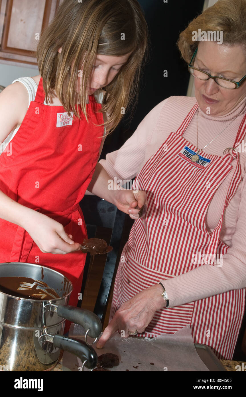 Family activity making home made chocolate covered peanut butter eggs a ...