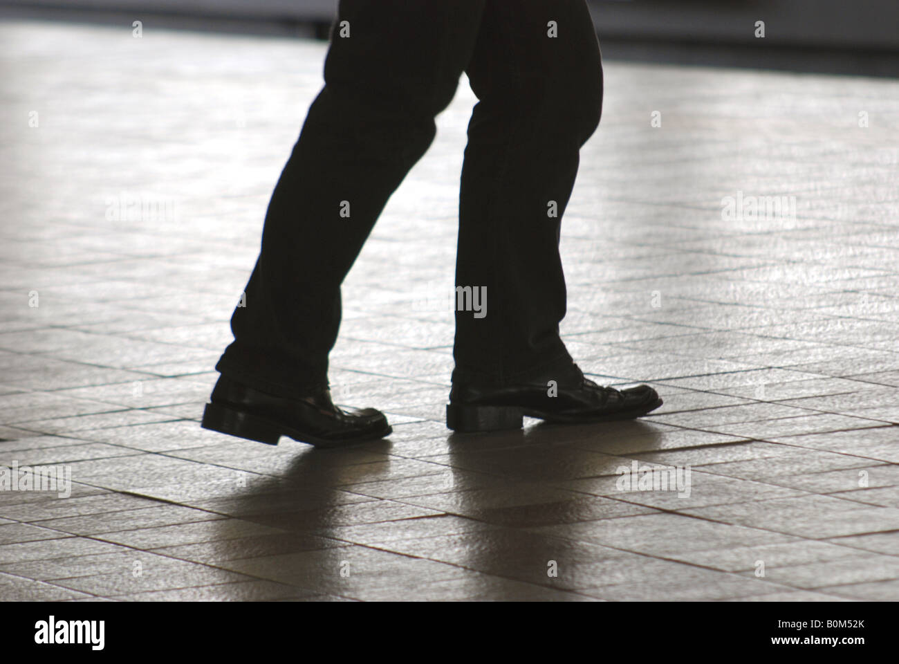 Closeup view of legs walking on tiled floor Stock Photo - Alamy