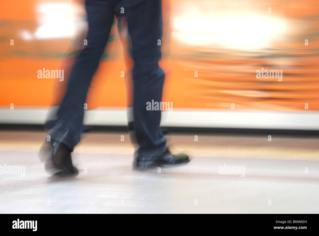 Closeup view of legs walking towards moving train Stock Photo - Alamy