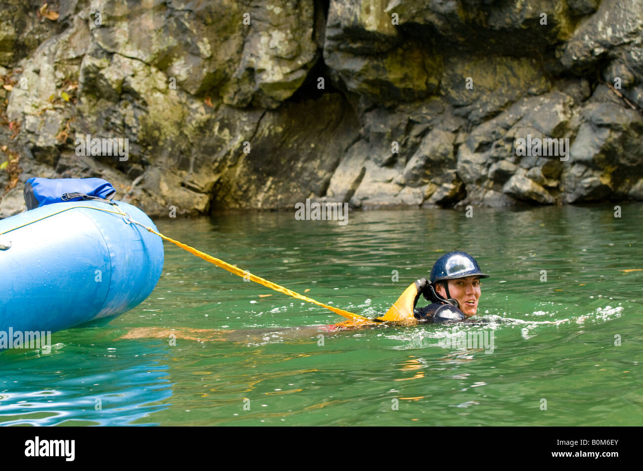 COSTA RICA Rafting Guide having fun towing raft down the Lower Pacuare ...