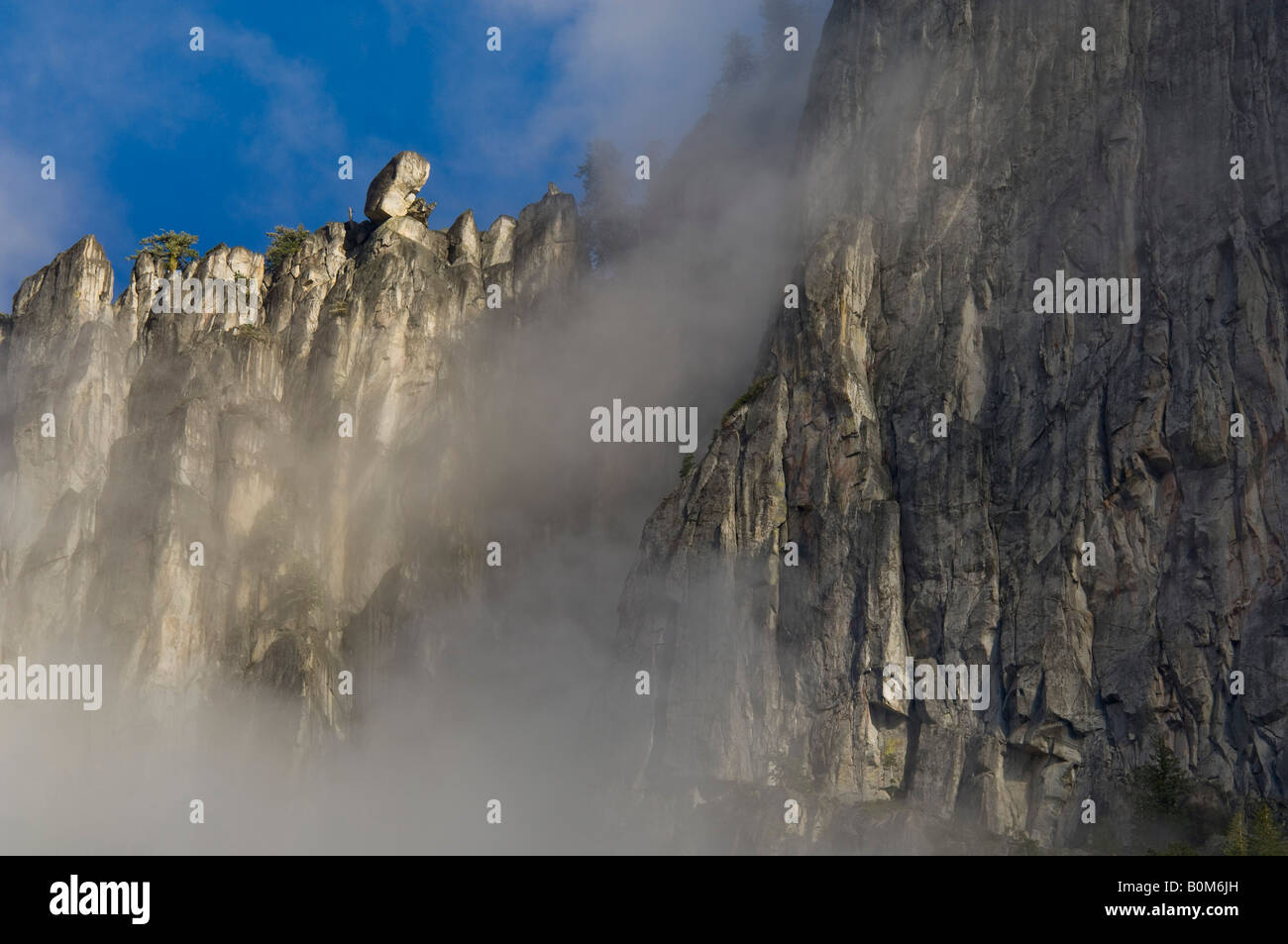Clouds and sheer granite cliff walls above Yosemite Valley Yosemite ...
