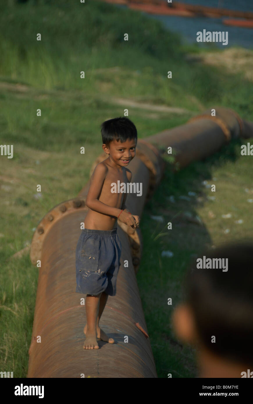 homeless children playing along the mekong river, cambodia Stock Photo ...