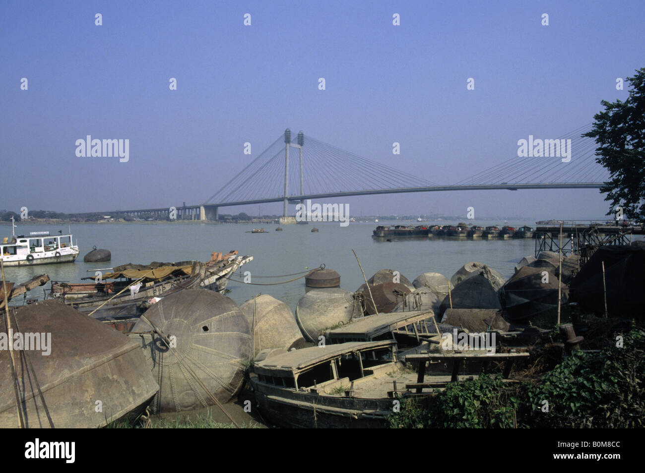 New bridge. Hooghly river. Boats moored. Large iron mooring bouys on ...