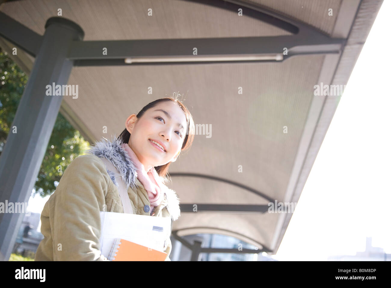 Japanese woman waiting for bus Stock Photo - Alamy