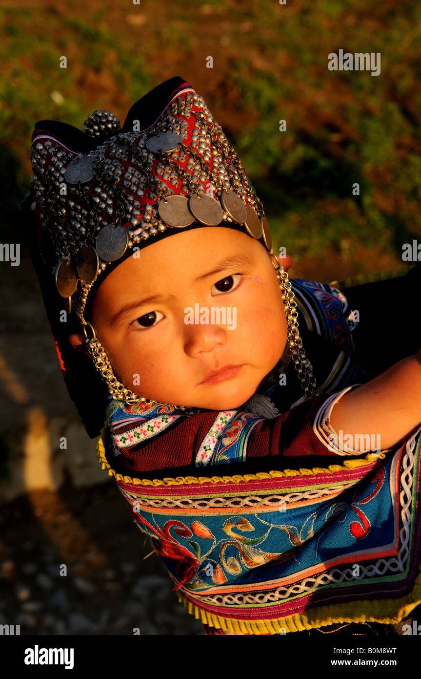 A very cute Hani baby on his mother s back Stock Photo - Alamy