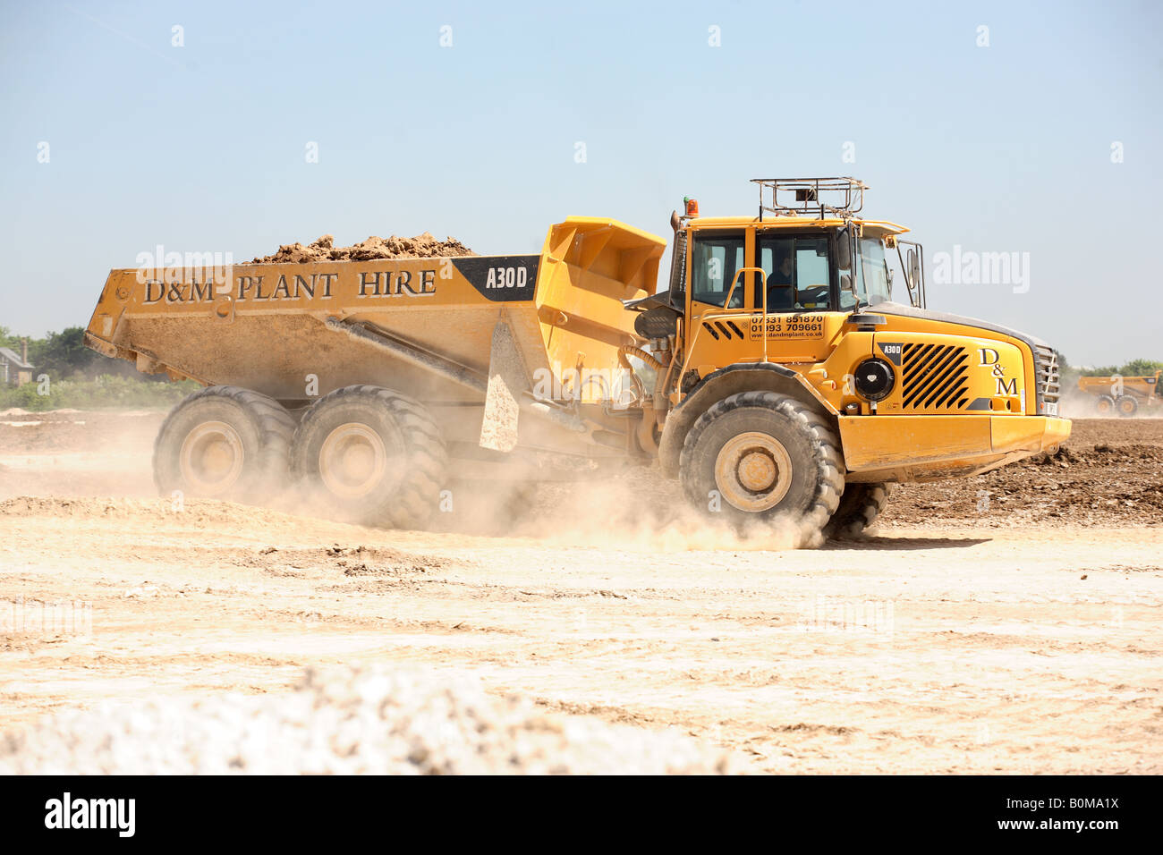 Large earth moving truck on building site Stock Photo - Alamy