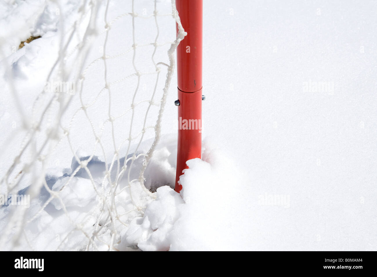 Goal post net in the snow Stock Photo - Alamy