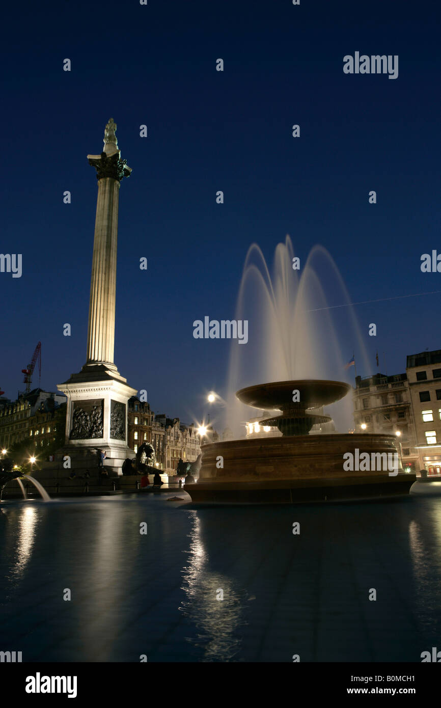 City of London, England. Night view of a water fountain in Trafalgar ...