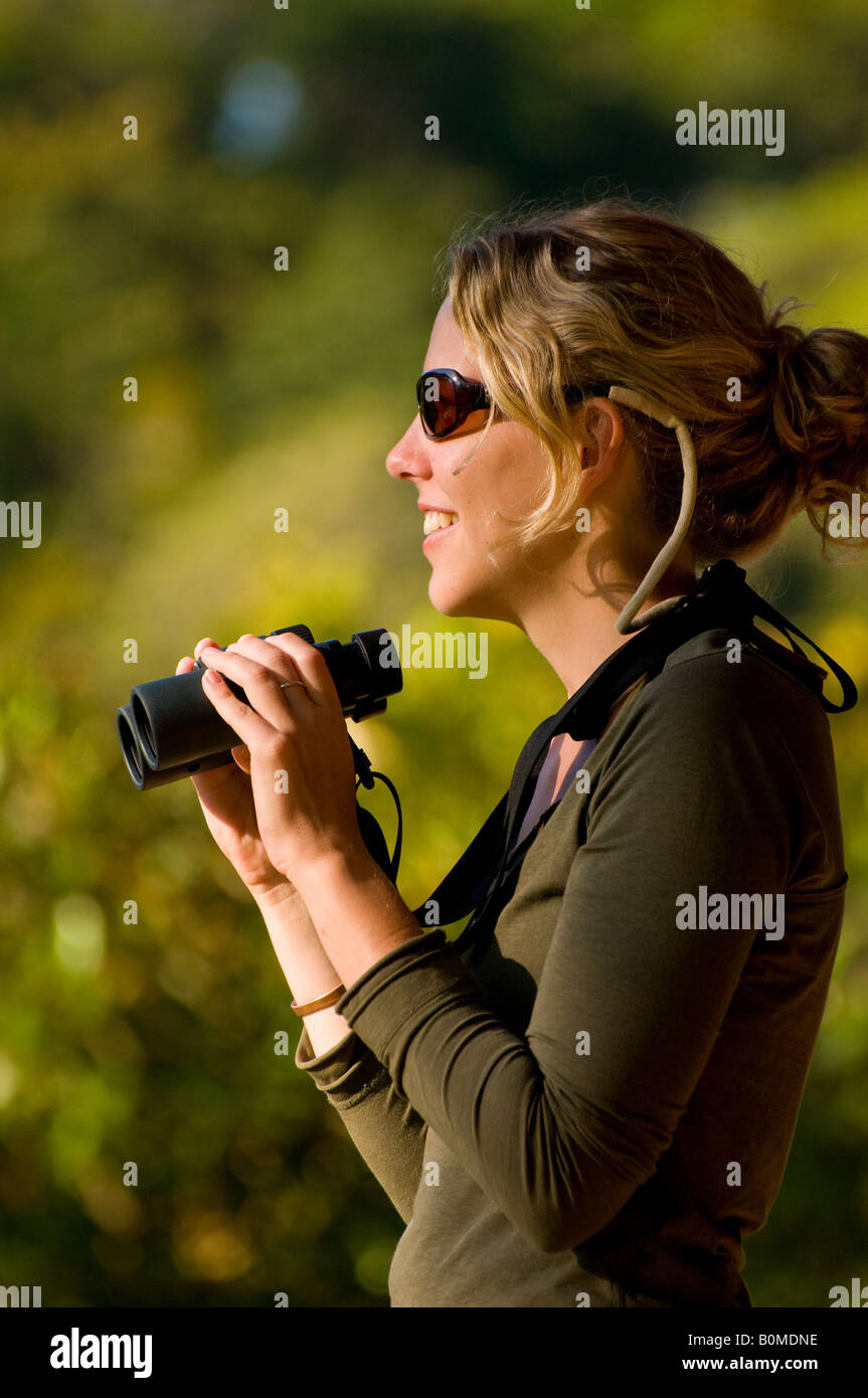 COSTA RICA Woman bird watching with binoculars in rainforest Stock ...