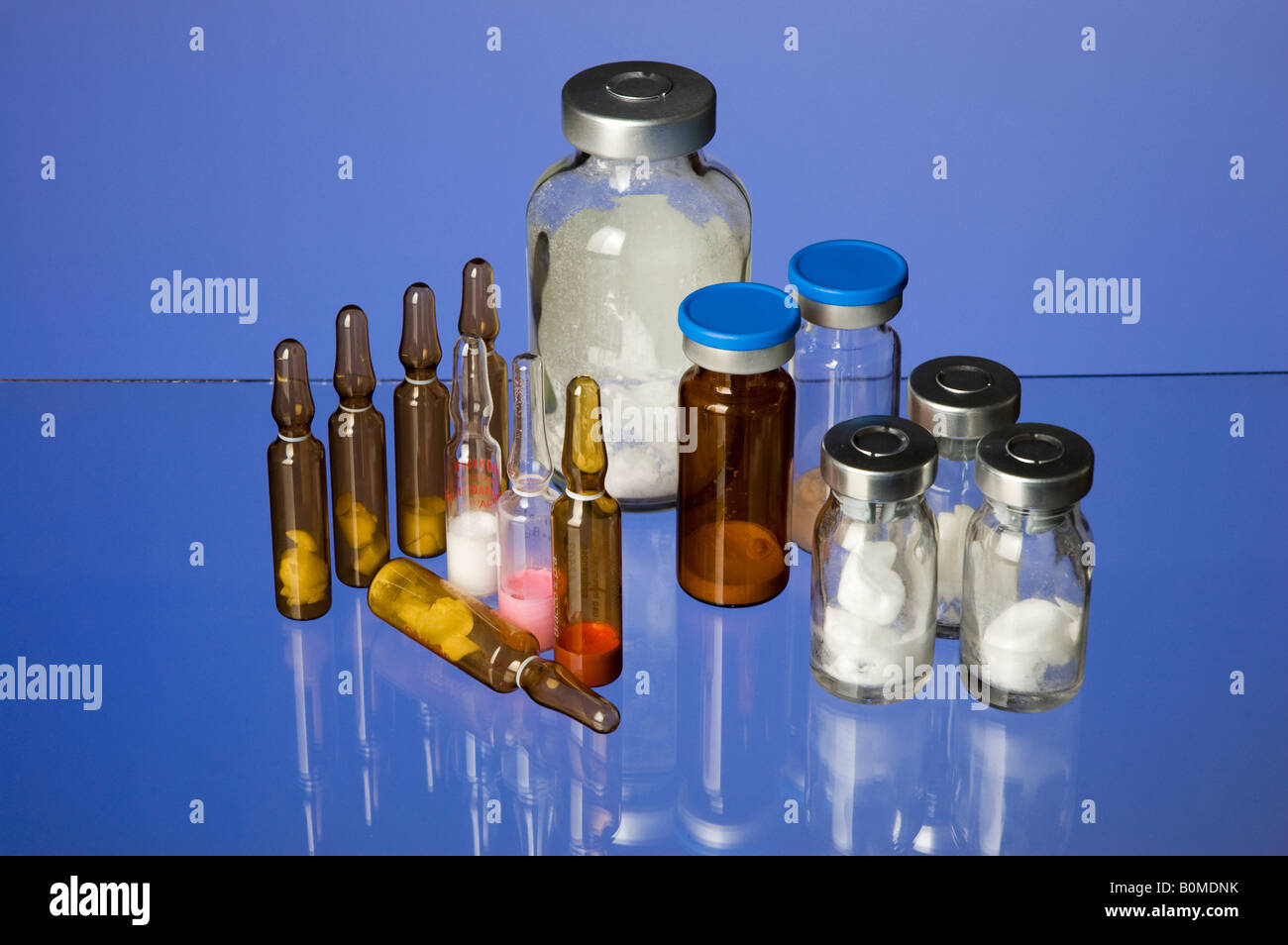Arrangement of assorted medical vials on blue background Stock Photo ...