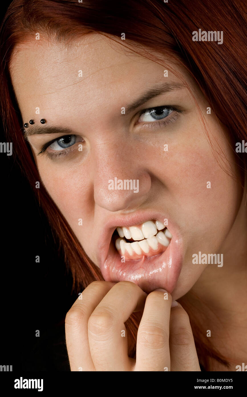 Beautiful girl showing teeth Stock Photo - Alamy