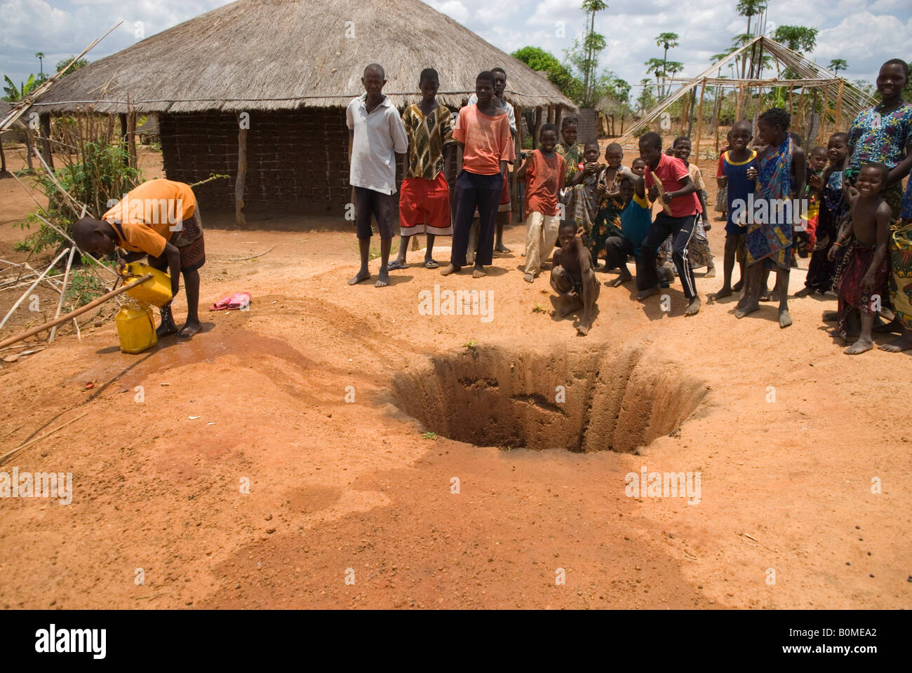 Villagers surrounding a water well in a village in the remote Niassa ...